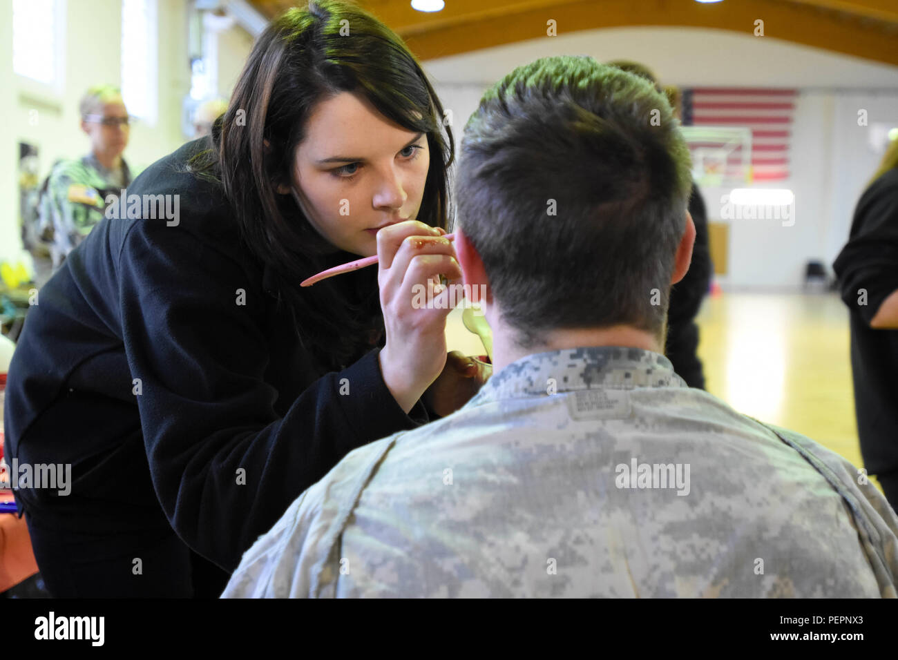 The moulage team prepares role players for patient play during 30th ...