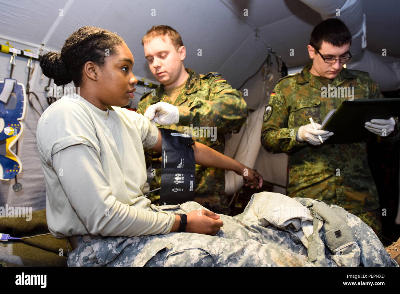 Bundeswehr medical providers at the Role 1 assess Pfc. Katia Blake, U.S ...