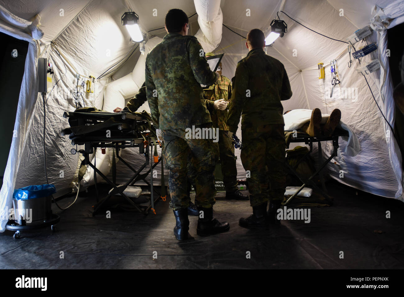 Bundeswehr medical providers at the Role 1 assess Pfc. Katia Blake, U.S ...