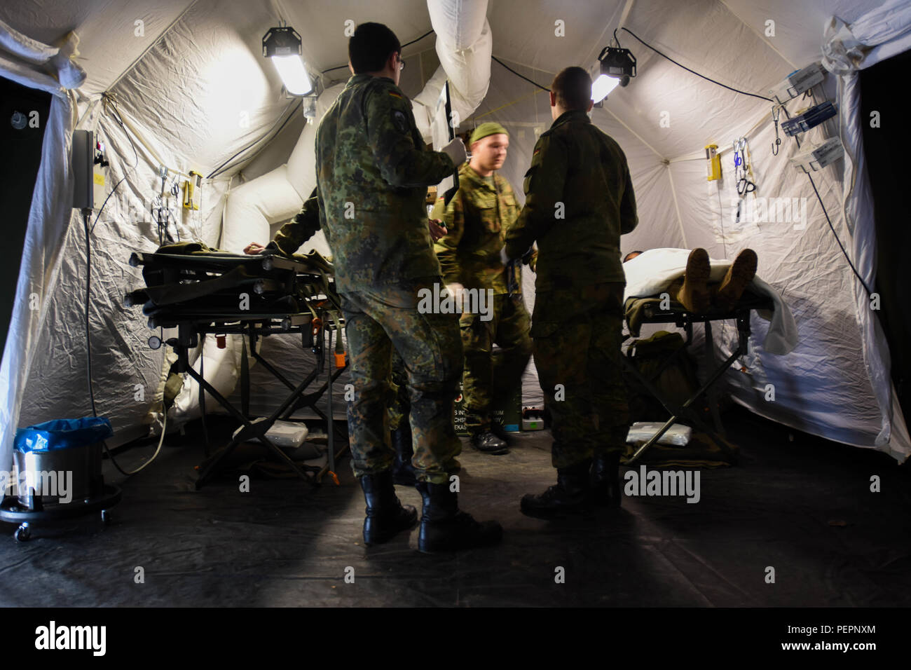Bundeswehr medical providers at the Role 1 assess Pfc. Katia Blake, U.S ...