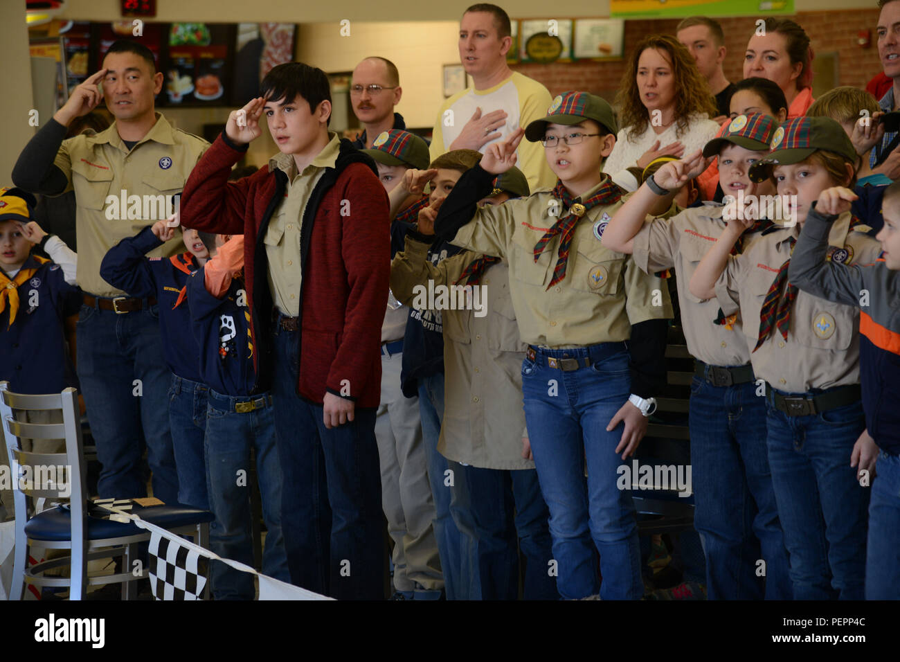 Members of Cub Scout Pack 89 salute during a color guard presentation ...