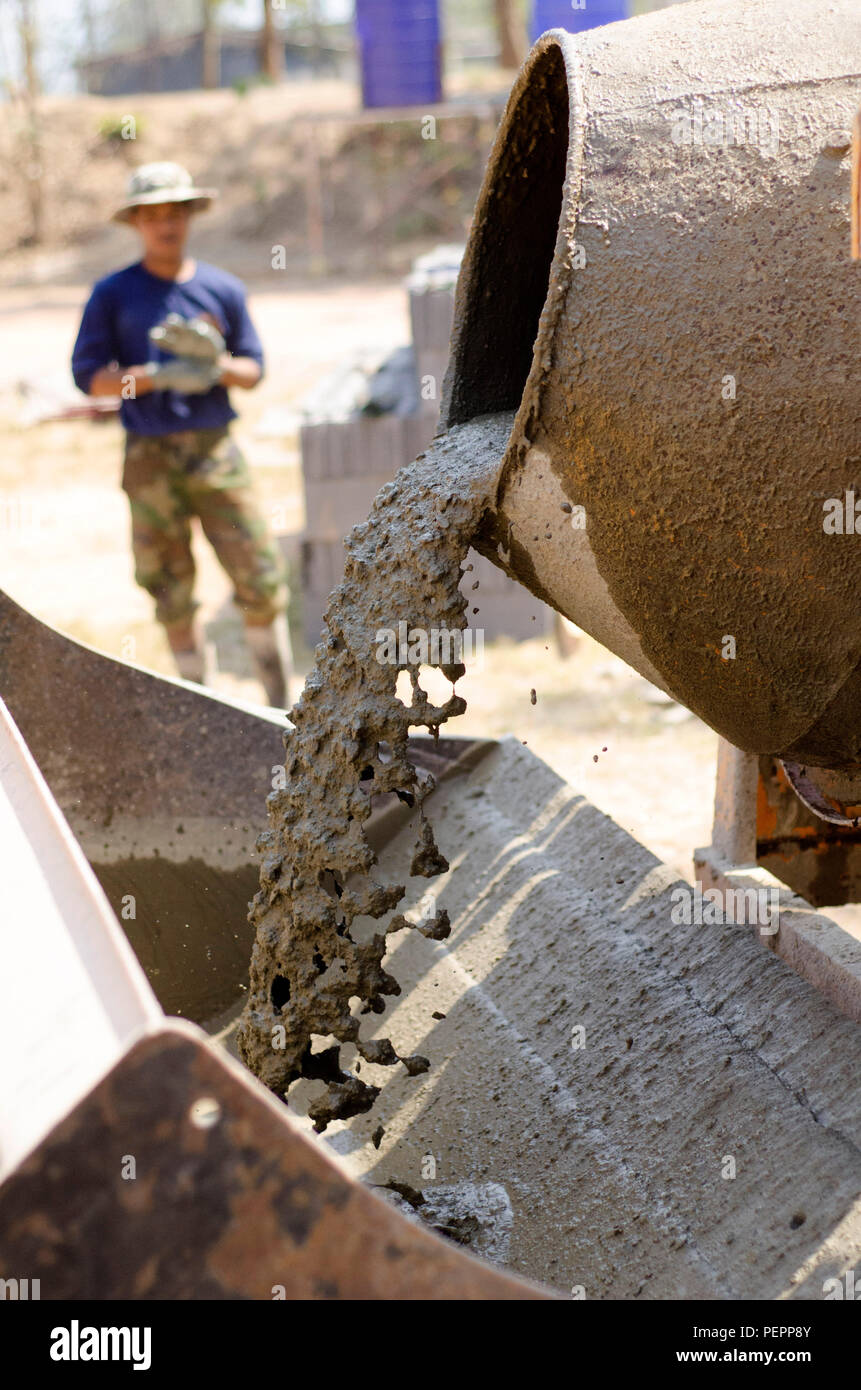 Cement for Ban Cham Kho school project in Rayong, Thailand, is poured ...