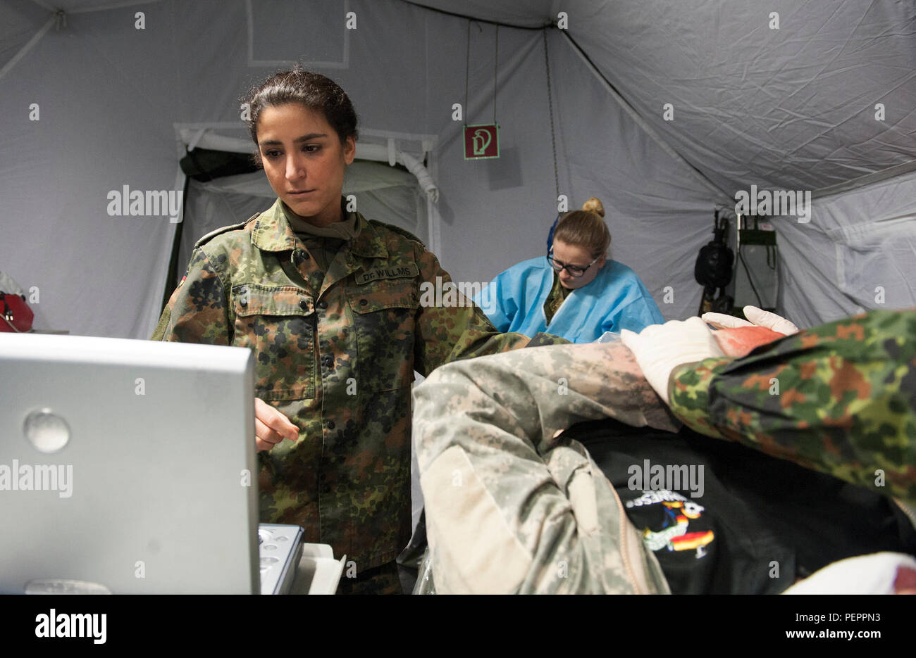 Dr. Willms, a member of the German Army (Bundeswehr), uses an ...