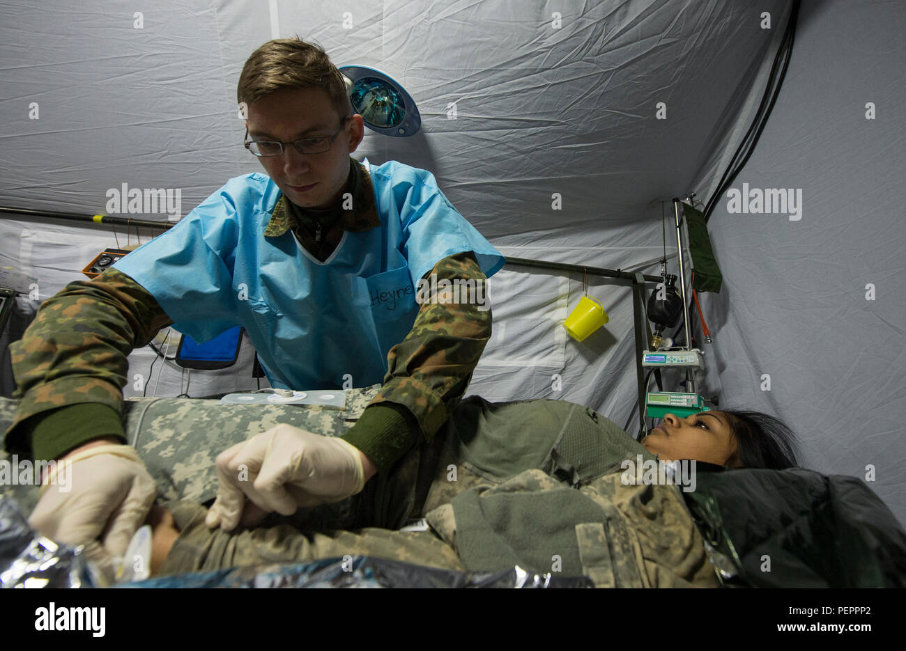 A medical soldier with the Germany army (Bundeswehr) tends to a ...