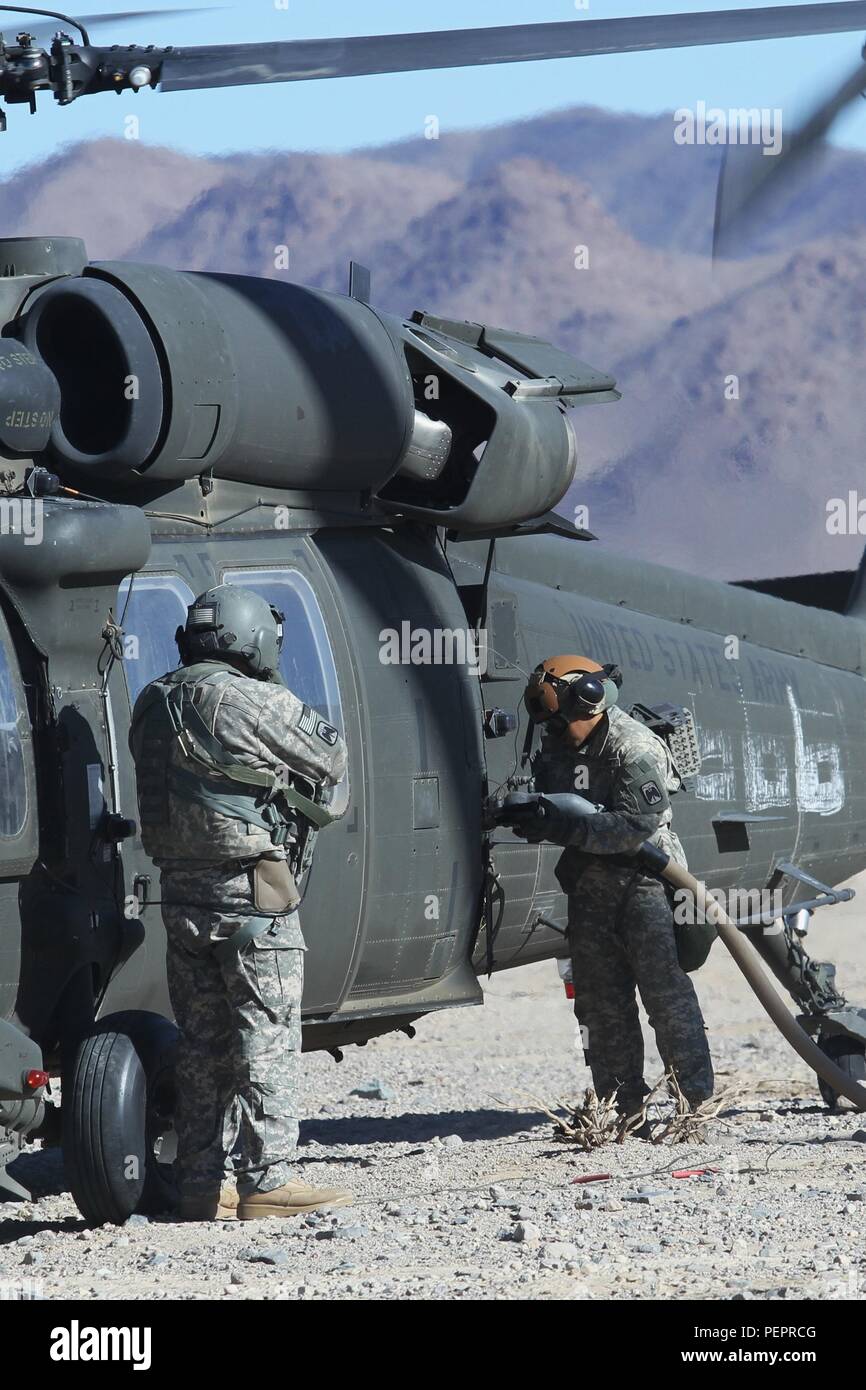 A U.S. Army Soldier assigned to 16th Combat Aviation Brigade refuels a ...