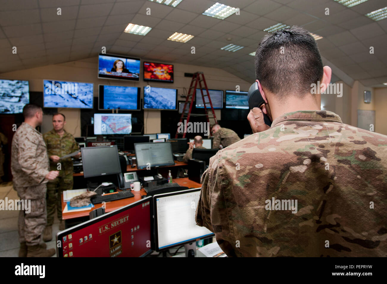 A coalition adviser takes a phone call from the Combined Joint ...