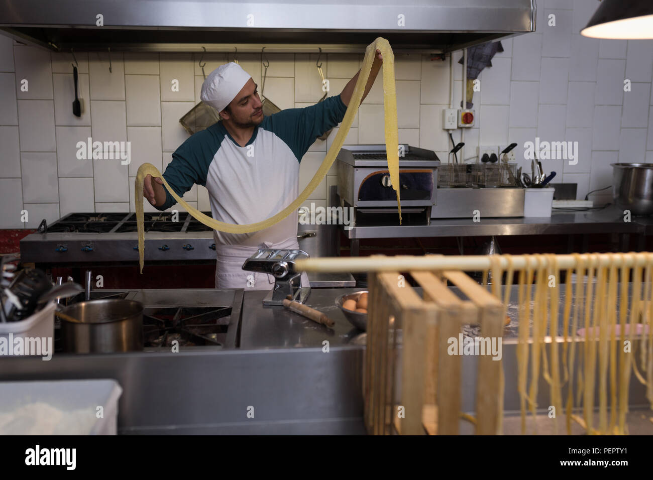 Baker preparing pasta in bakery Stock Photo - Alamy