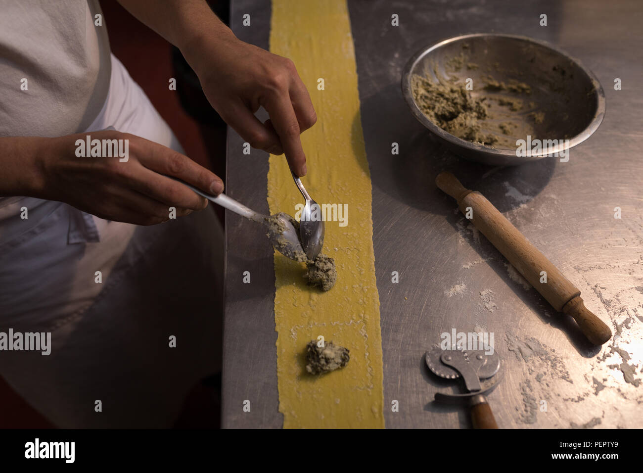Baker preparing pasta in bakery Stock Photo - Alamy