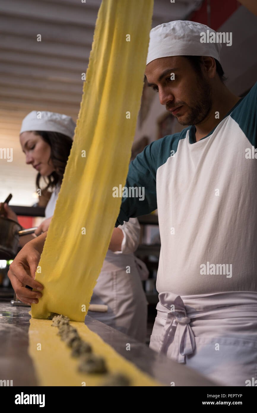 Bakers preparing pasta in bakery Stock Photo - Alamy