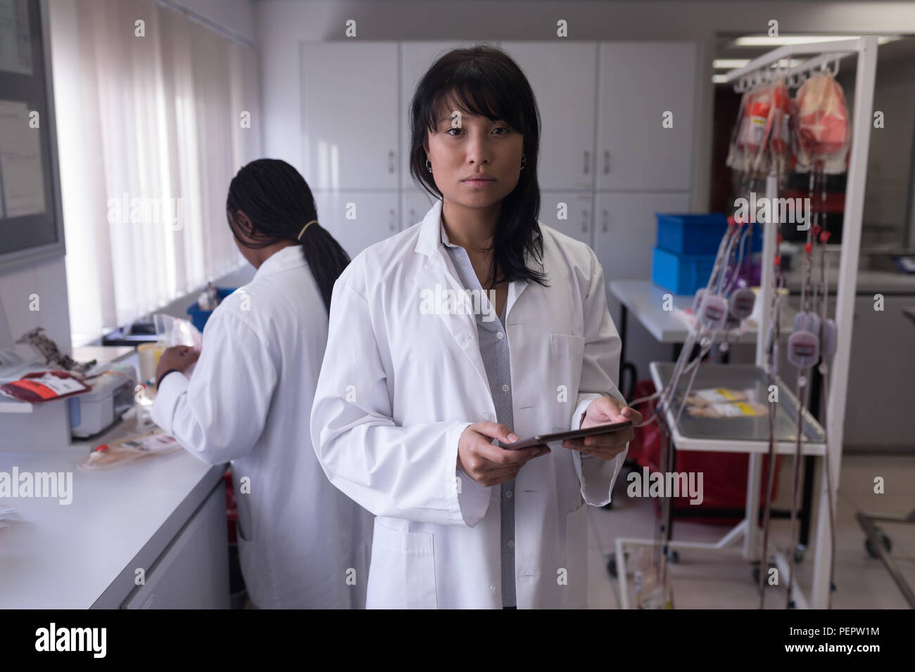 Black doctor using digital tablet hi-res stock photography and images ...