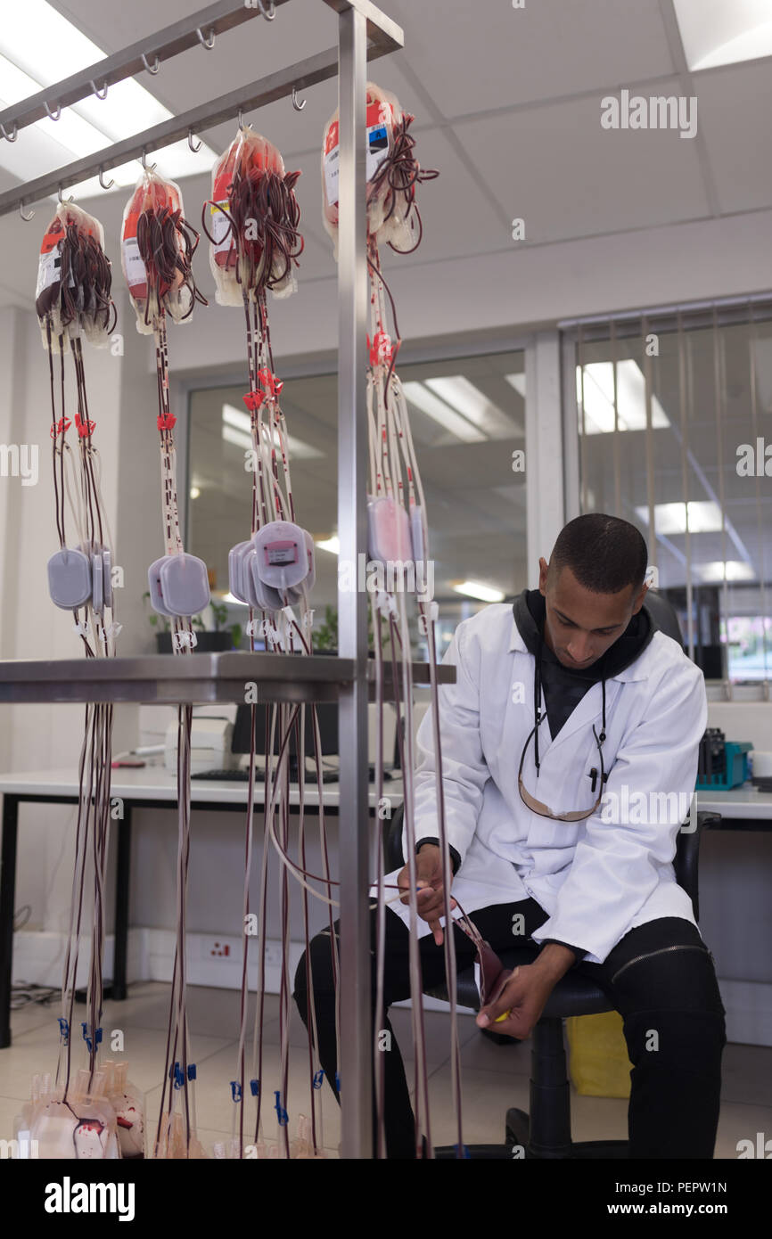Laboratory technician analyzing blood bag Stock Photo - Alamy