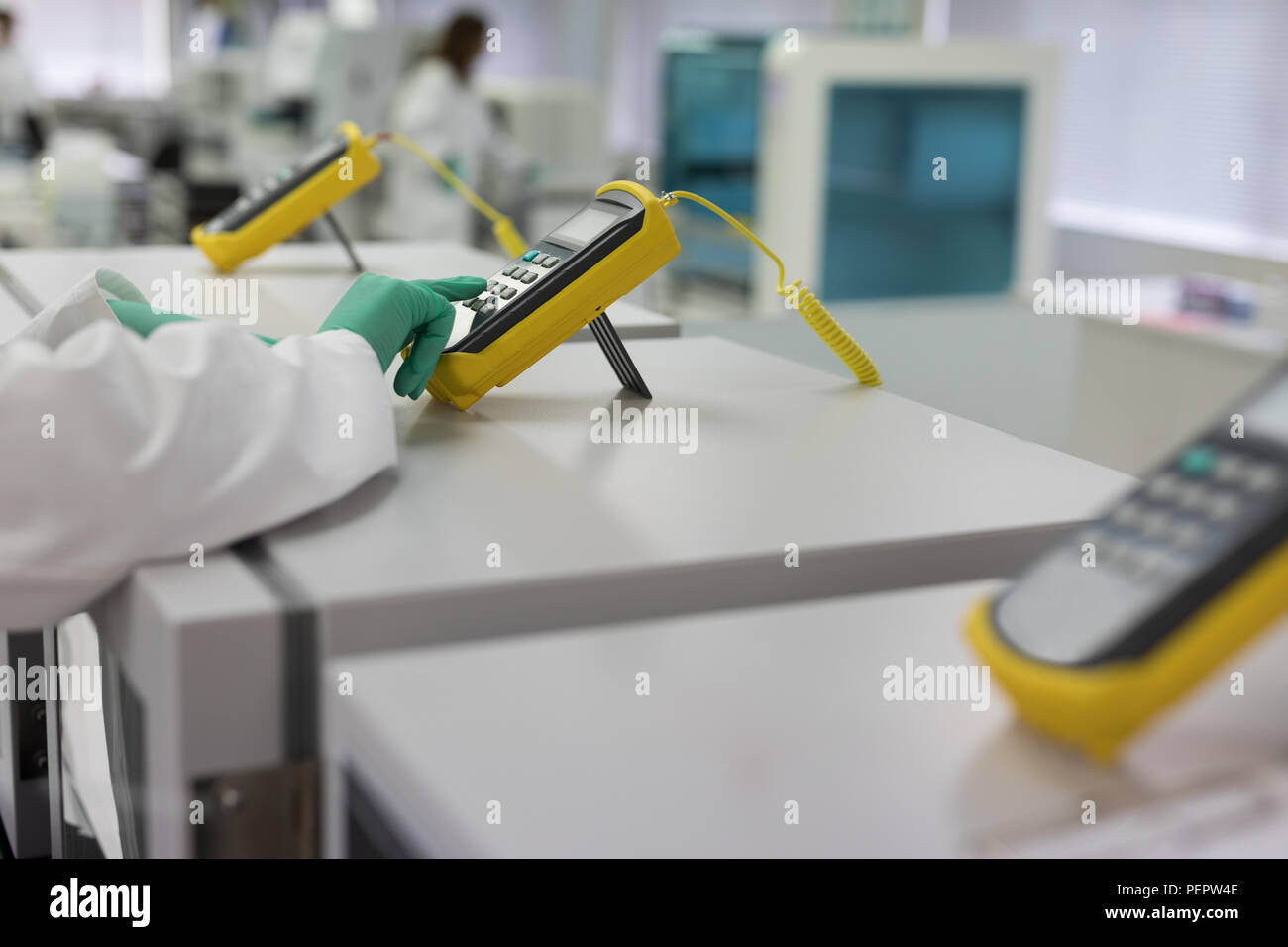 Laboratory technician using electronic device Stock Photo - Alamy