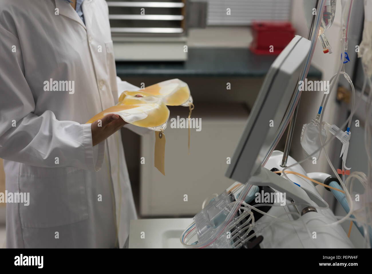 Laboratory technician holding plasma bags Stock Photo - Alamy