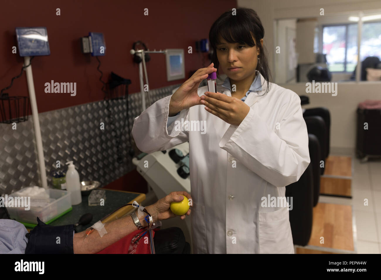 Physician checking blood sample Stock Photo - Alamy