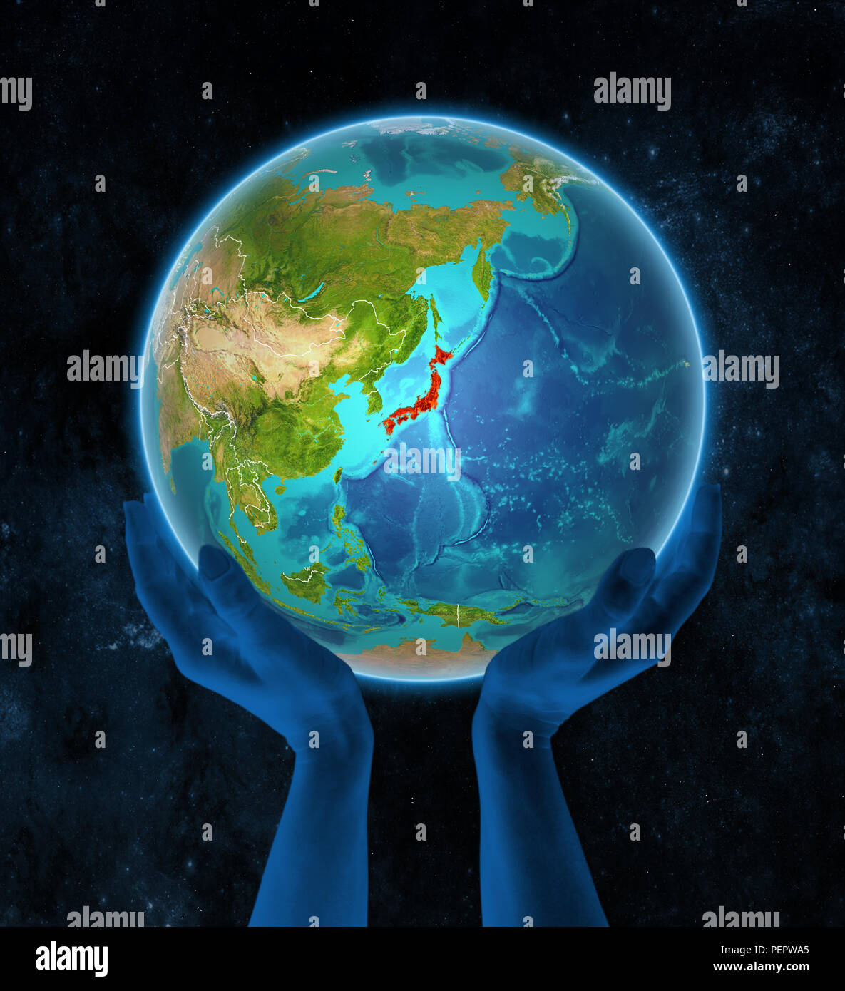 Japan on planet Earth with visible country borders in hands in space ...