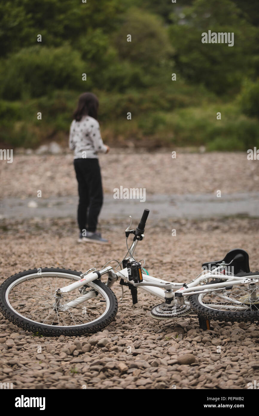 Girl standing near river side Stock Photo - Alamy