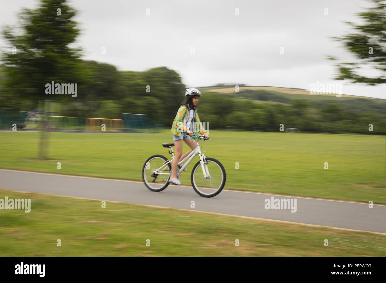 Girl riding bicycle on street Stock Photo - Alamy