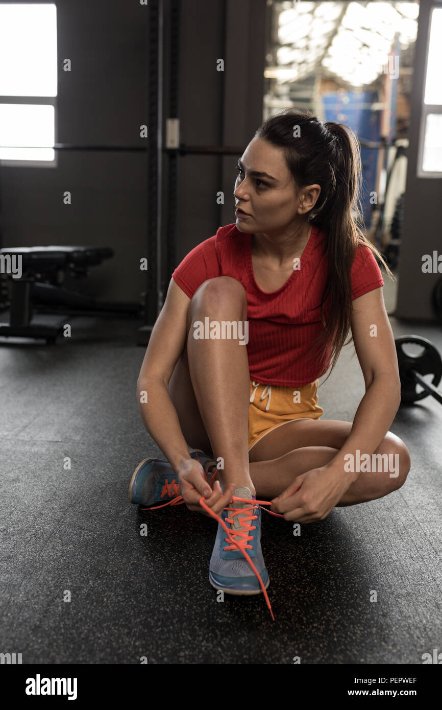 Woman tying sneakers hi-res stock photography and images - Alamy