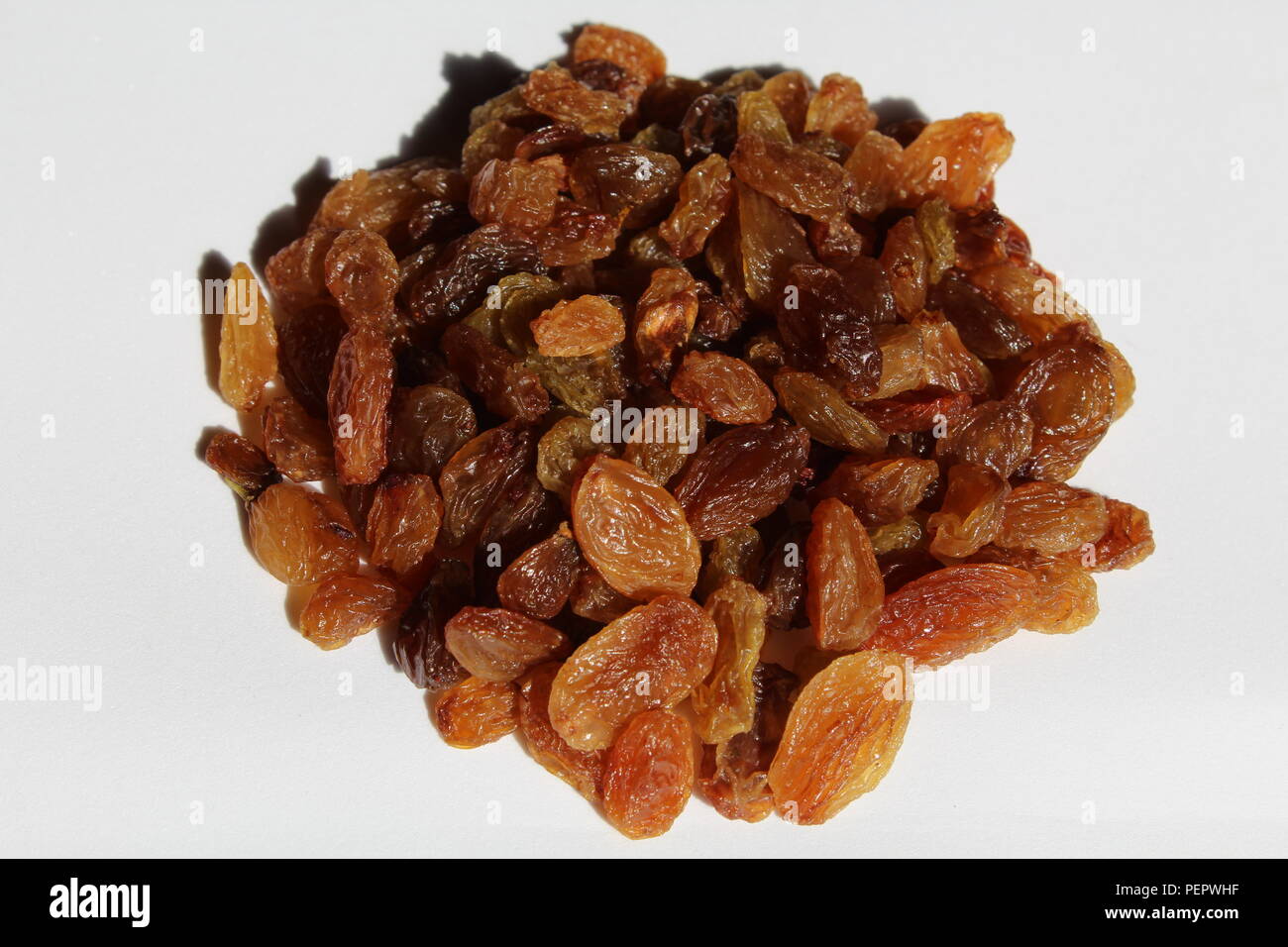 Sweet raisins isolated on white background Stock Photo - Alamy