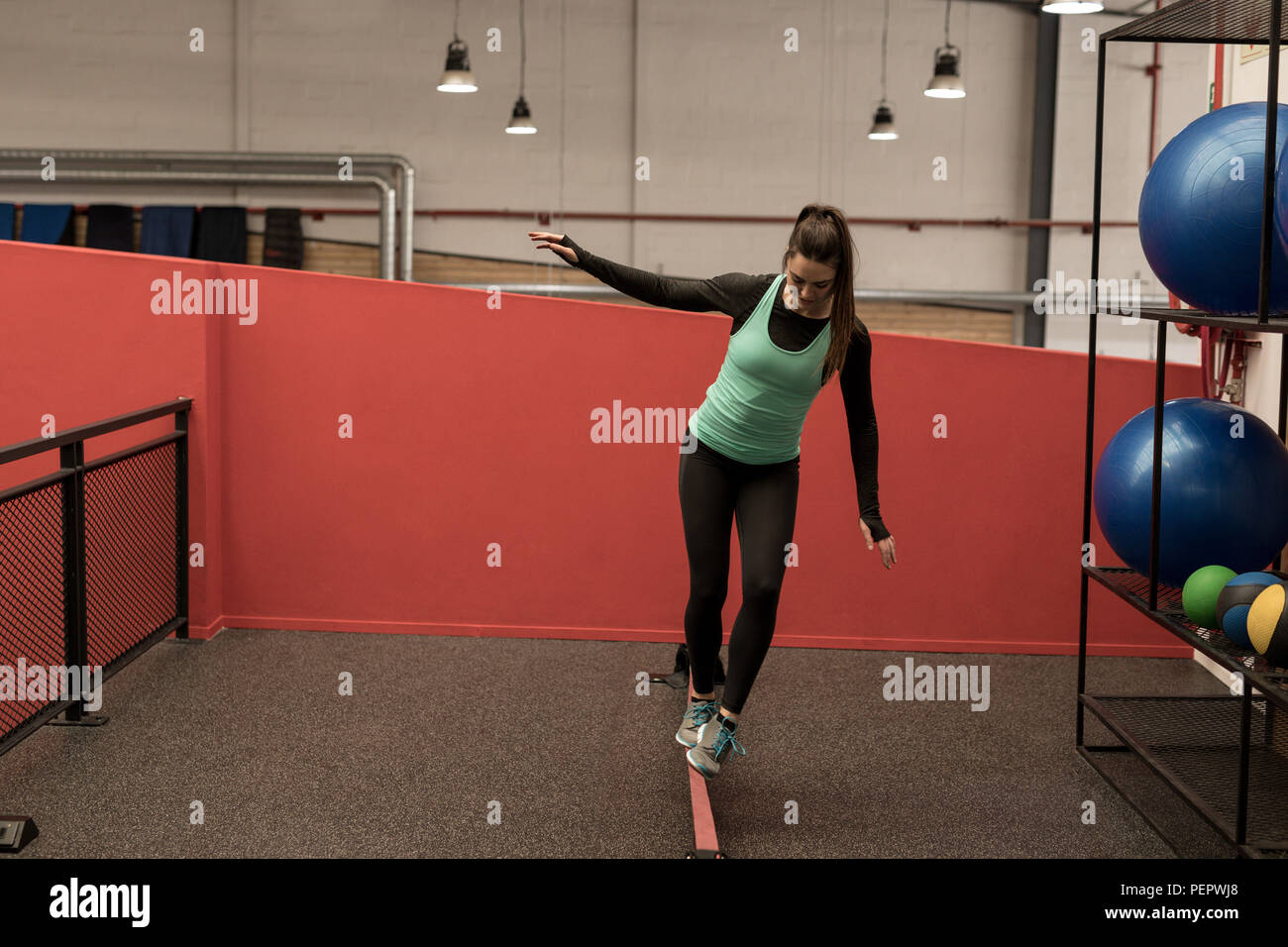 Woman doing exercise with rubber band in fitness gym Stock Photo - Alamy