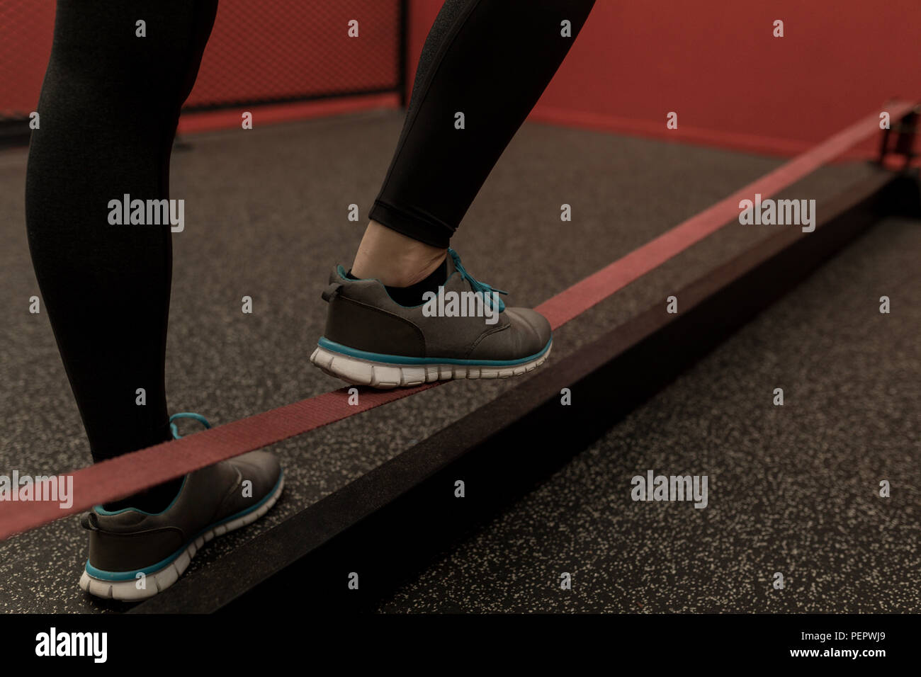 Woman doing exercise with rubber band in fitness gym Stock Photo - Alamy