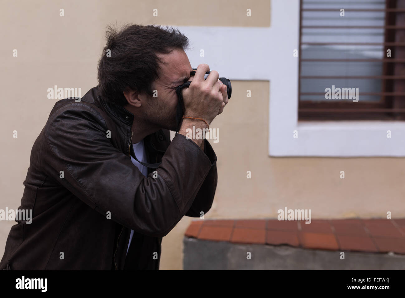 Male photographer clicking photos Stock Photo - Alamy