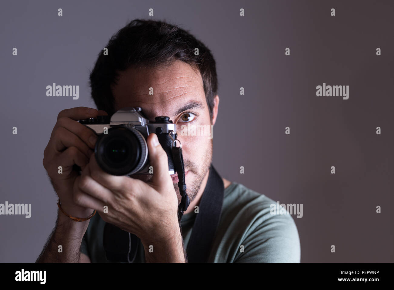 Male photographer clicking photos with camera Stock Photo - Alamy