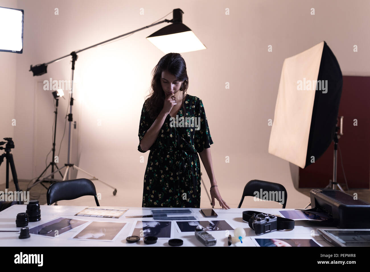 Female photographer looking at photographs Stock Photo - Alamy
