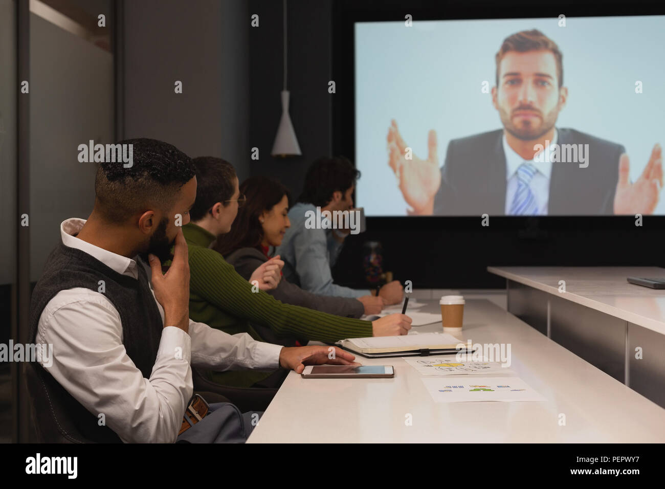 Business people interacting through video call in conference Stock ...