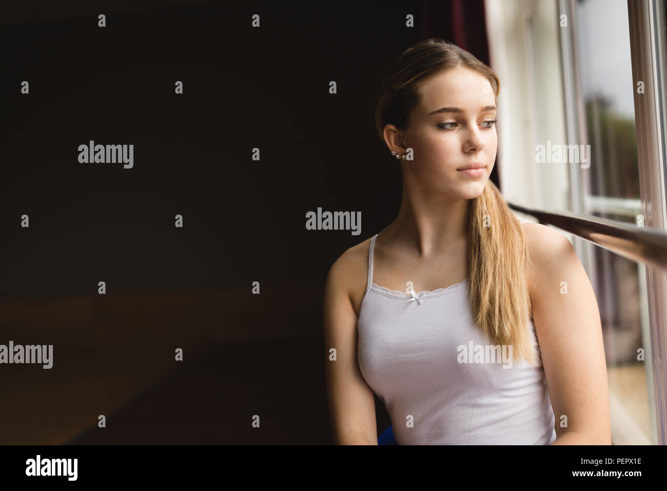 Ballerina looking through window Stock Photo - Alamy