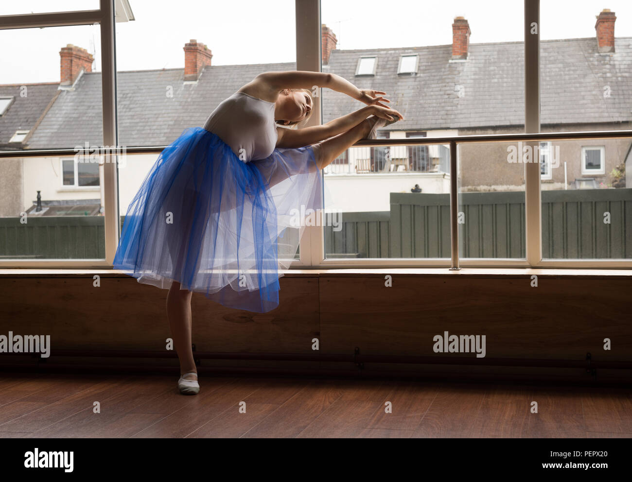 Ballerina practicing ballet dance near window Stock Photo - Alamy