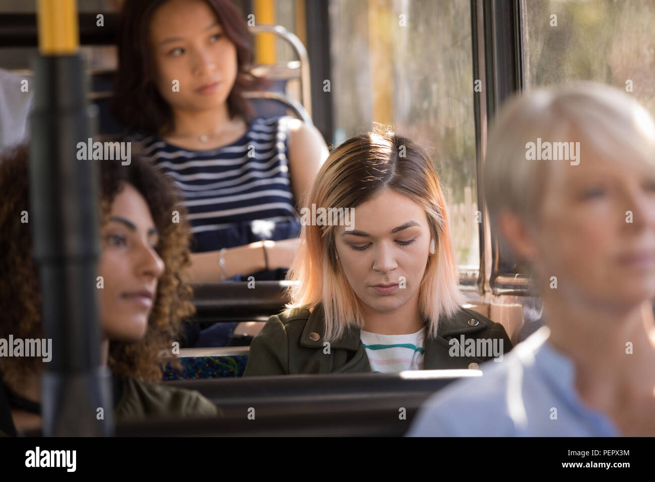 Female commuter travelling in modern bus Stock Photo - Alamy