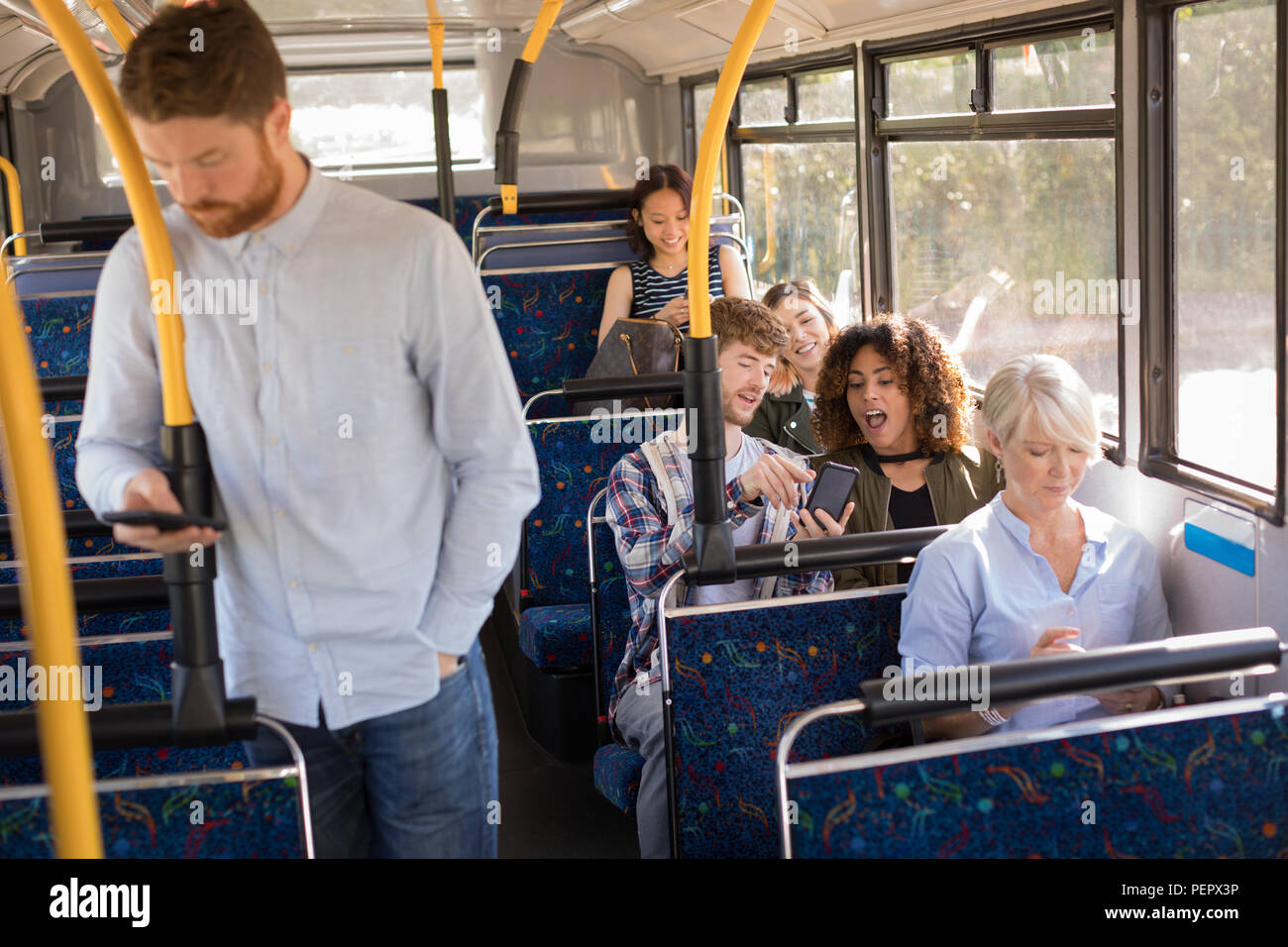 Male commuter using mobile phone while travelling in modern bus Stock ...