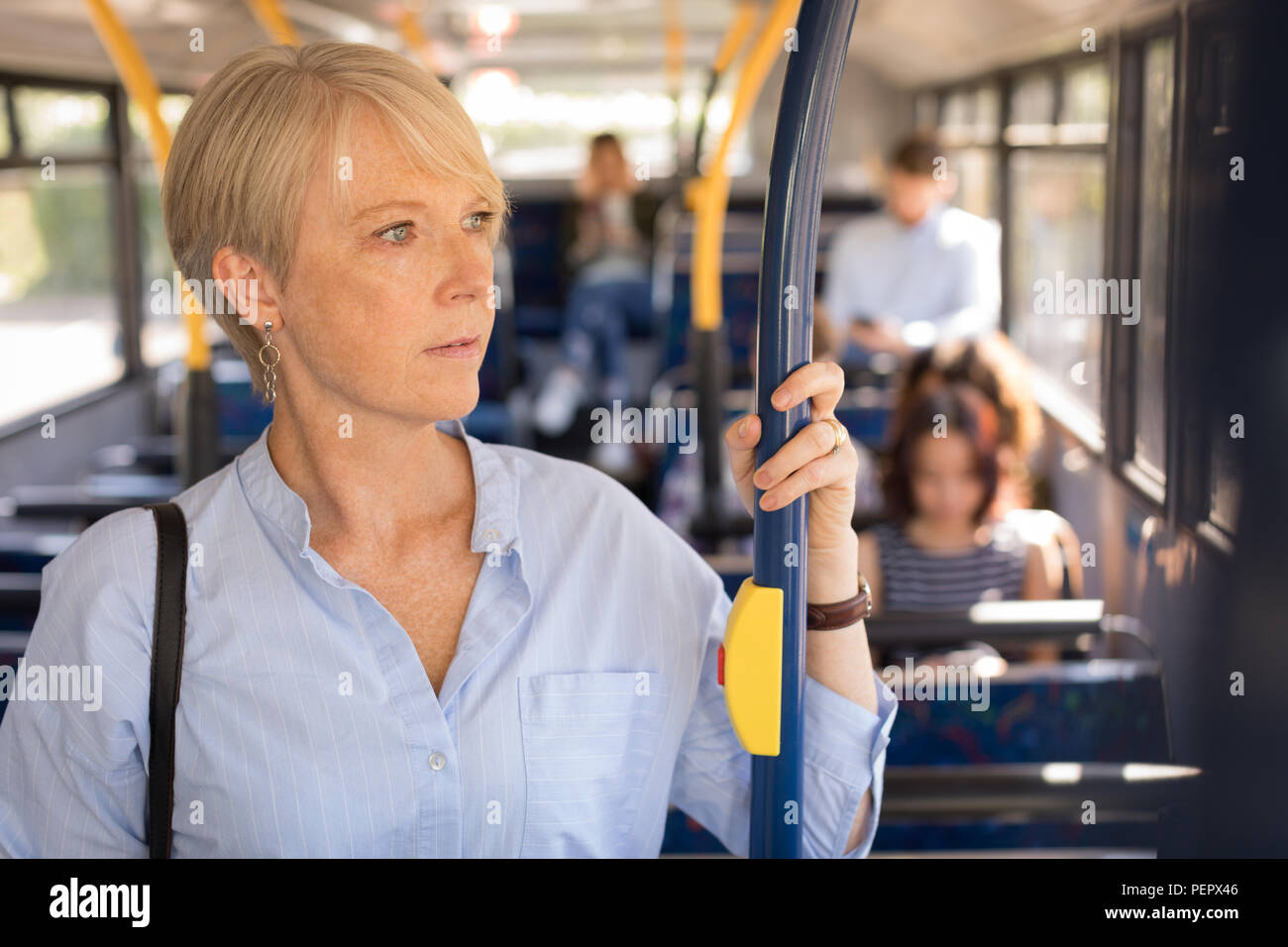 Female commuter travelling in bus Stock Photo - Alamy