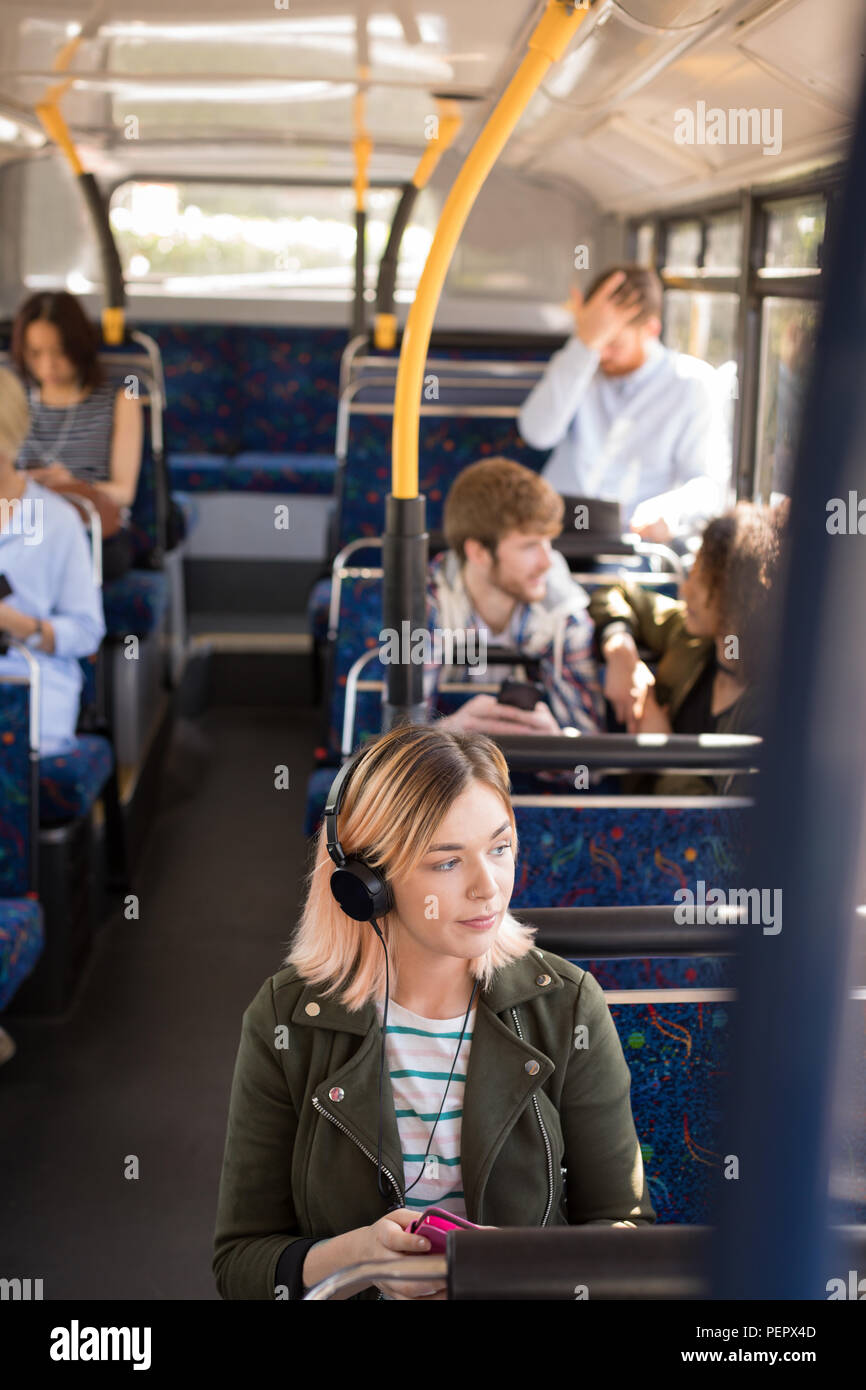 Female commuter listening music while travelling in modern bus Stock ...