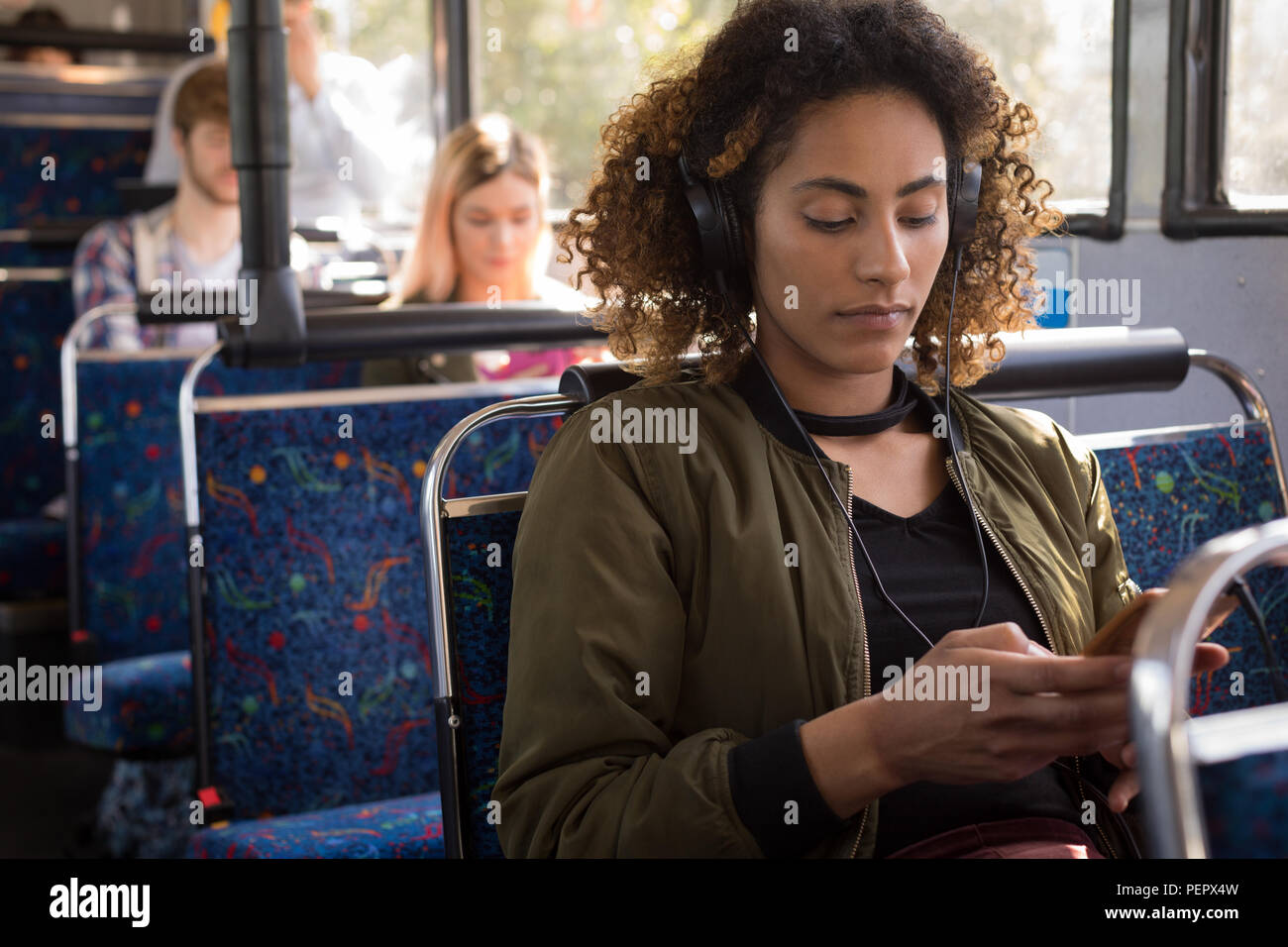 Female commuter listening music while travelling in modern bus Stock ...