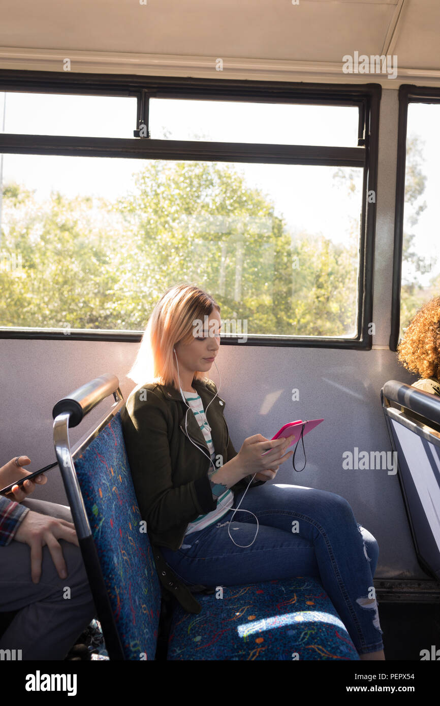 Woman listening music while travelling in modern bus Stock Photo - Alamy