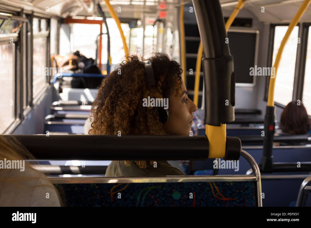 Female commuter listening music while travelling in modern bus Stock ...