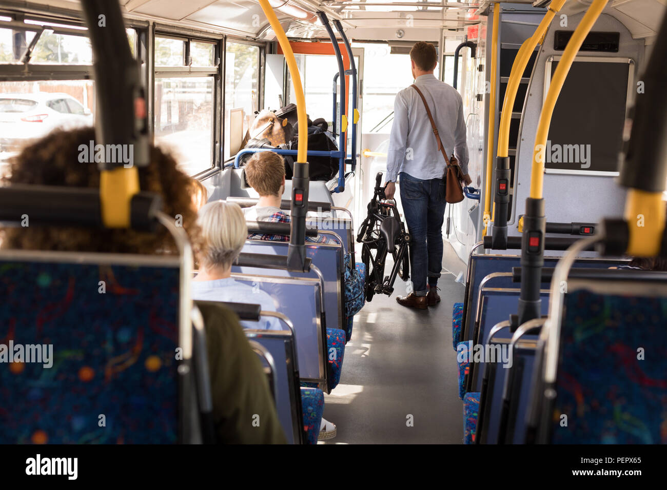 Man with folding bicycle entering in modern bus Stock Photo - Alamy