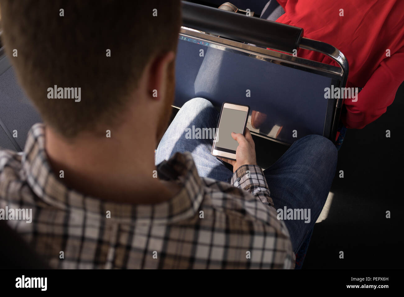 Male commuter using mobile phone while travelling in modern bus Stock ...