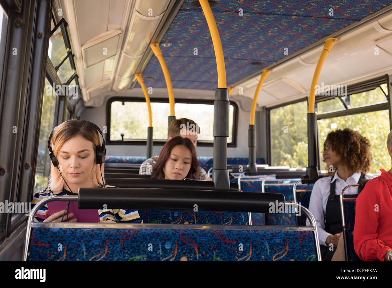 Female commuter listening music while travelling in modern bus Stock ...