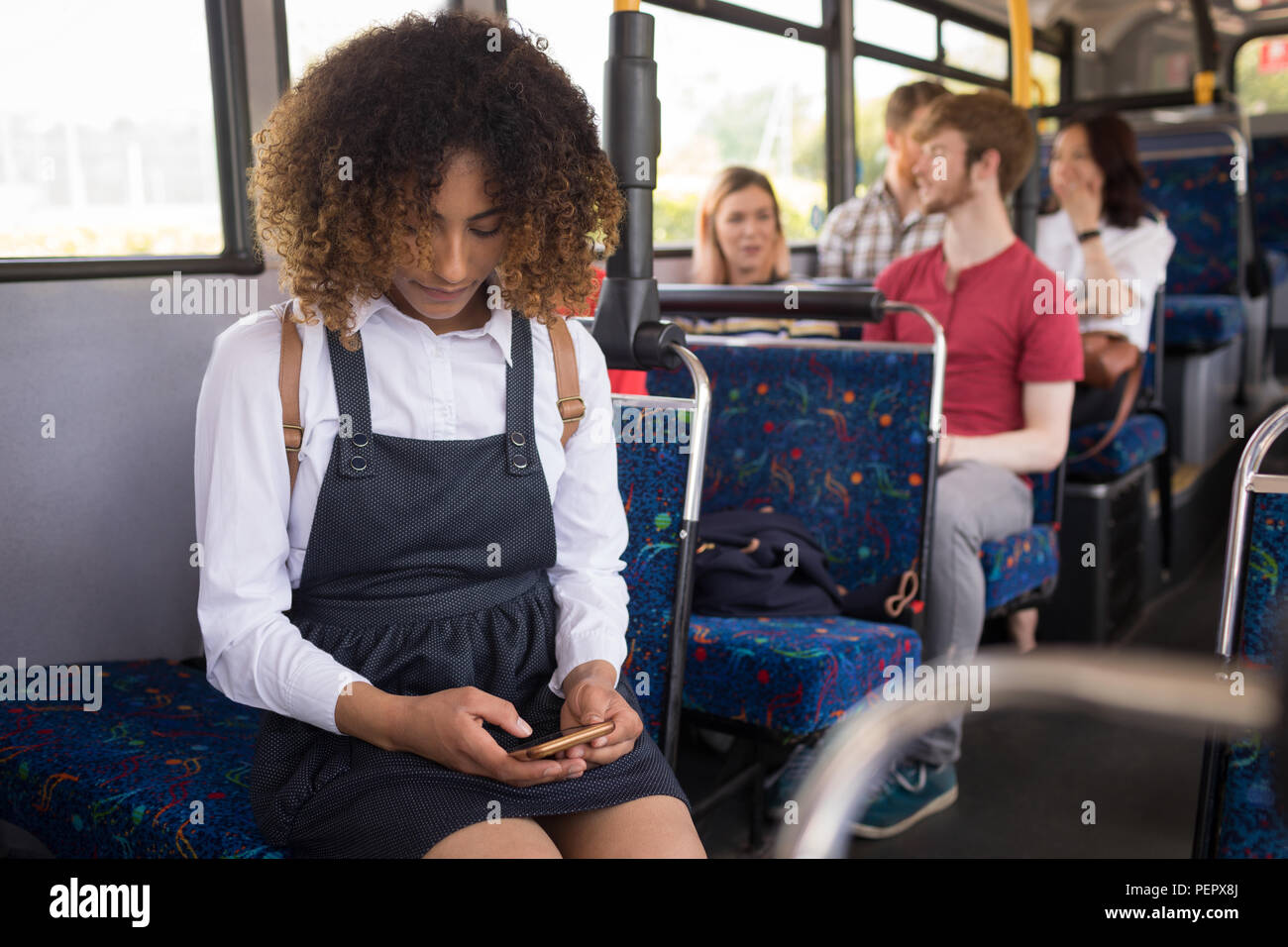 Female commuter using mobile phone while travelling in modern bus Stock ...