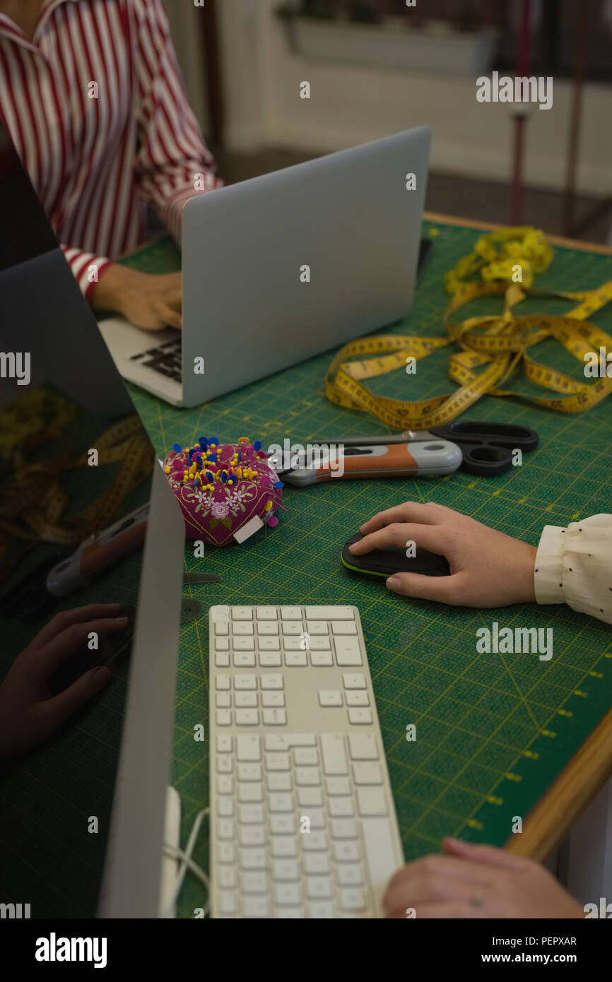 Fashion designers using computer and laptop Stock Photo - Alamy