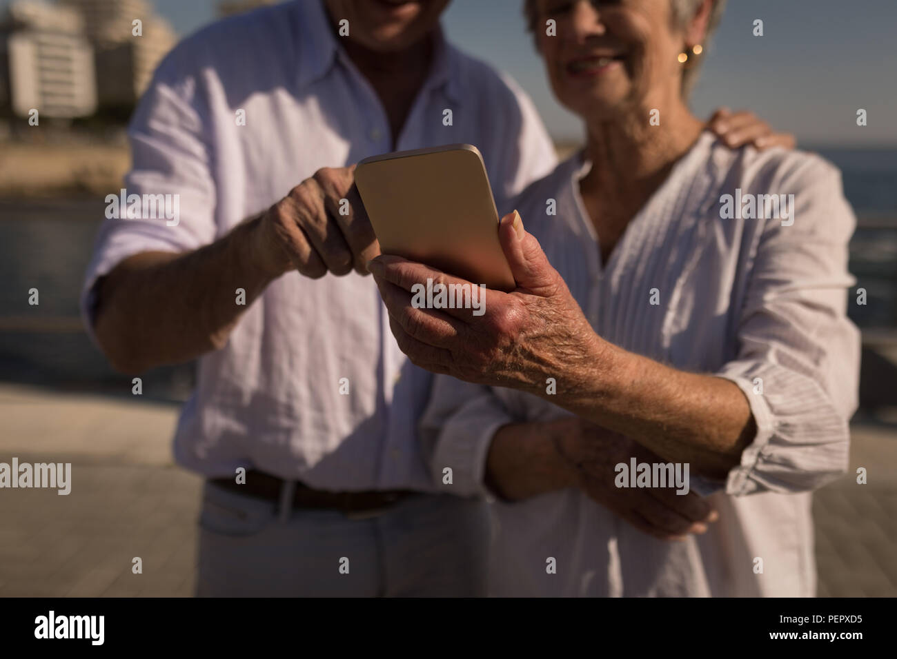 Senior couple using mobile phone Stock Photo - Alamy