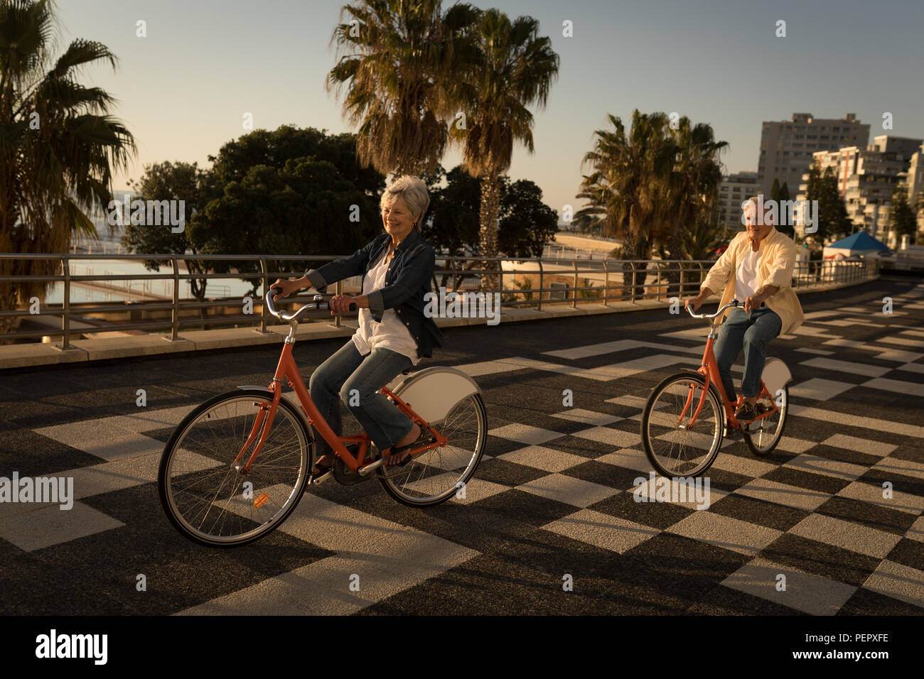 Elderly woman riding bicycle hi-res stock photography and images - Alamy