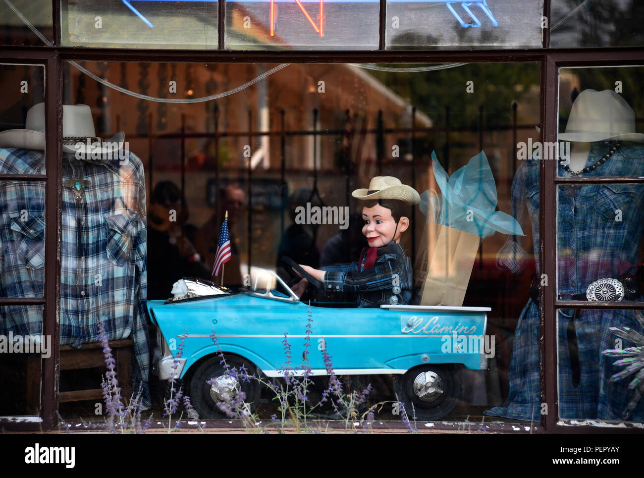 A store window display includes a Howdy Doody doll in a toy car Stock ...