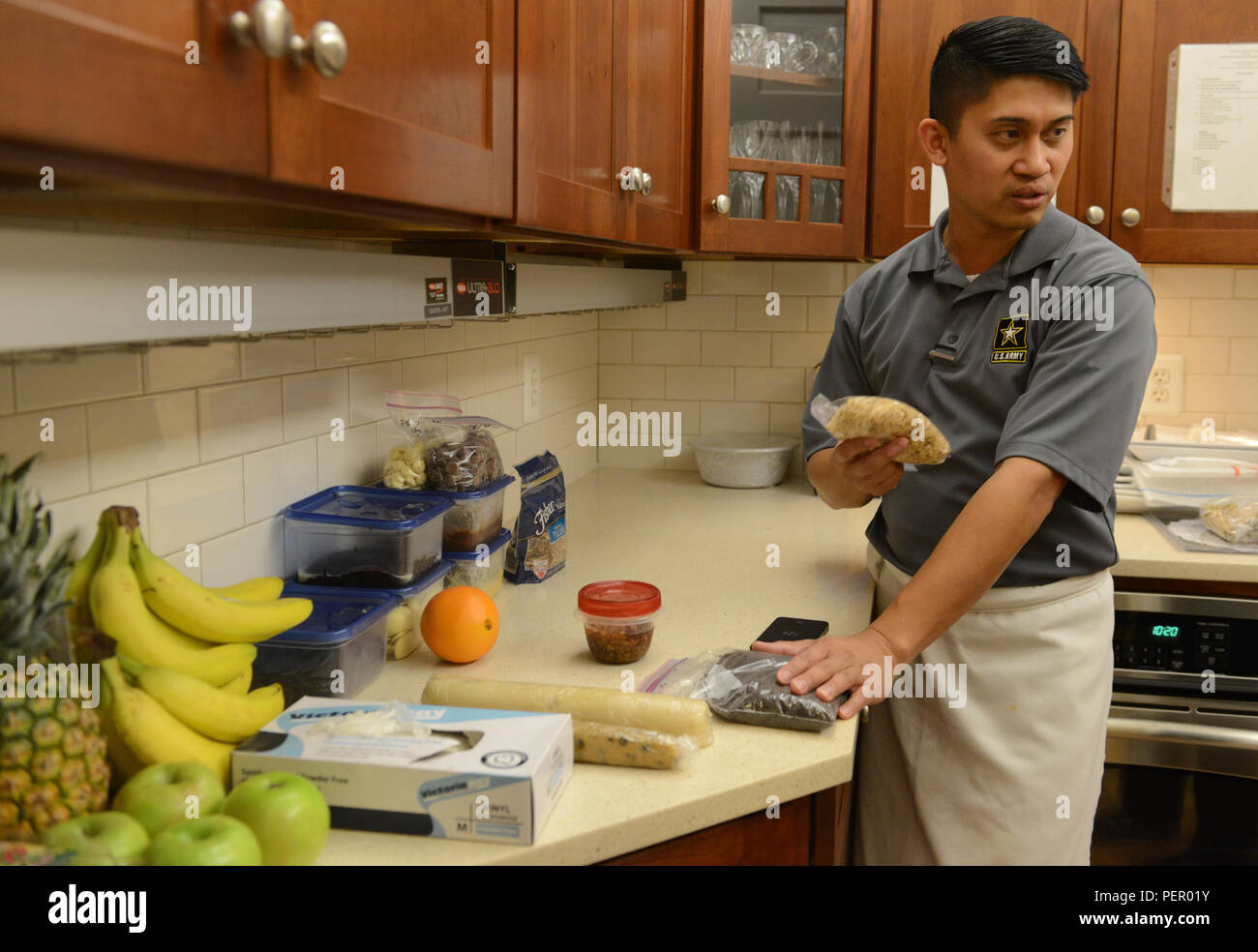 Enlisted Aide of the Year Staff Sgt. Marc Susa prepares a meal for the ...
