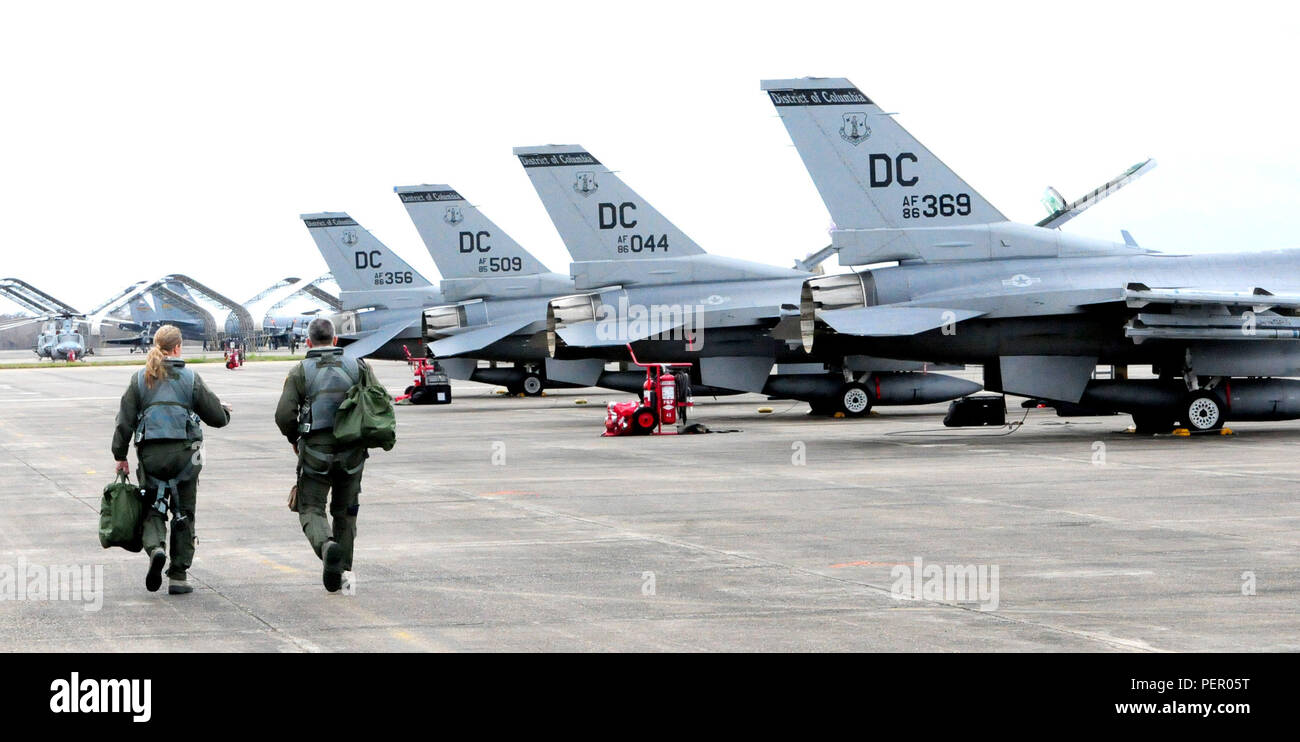 A 113th Wing pilot walks alongside a familiarization flight recipient ...