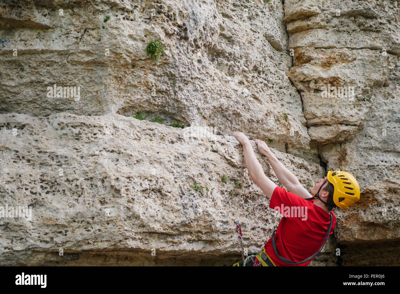 Strong guy climbs up rock hi-res stock photography and images - Alamy