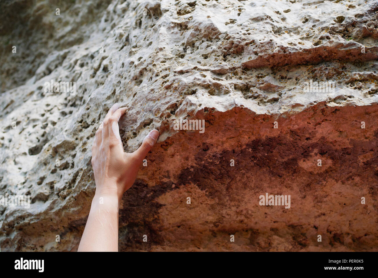 Picture of man's hand clambering over rock Stock Photo - Alamy